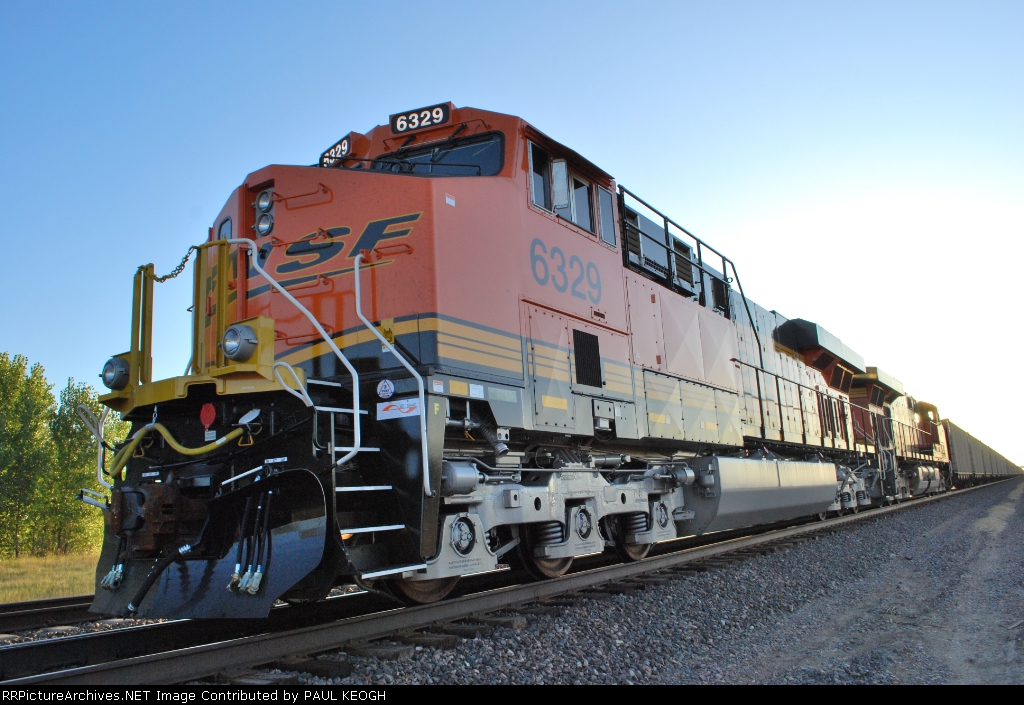 BNSF 6329 waits to roll west with a loaded coal train as the sun starts to rise behind her.